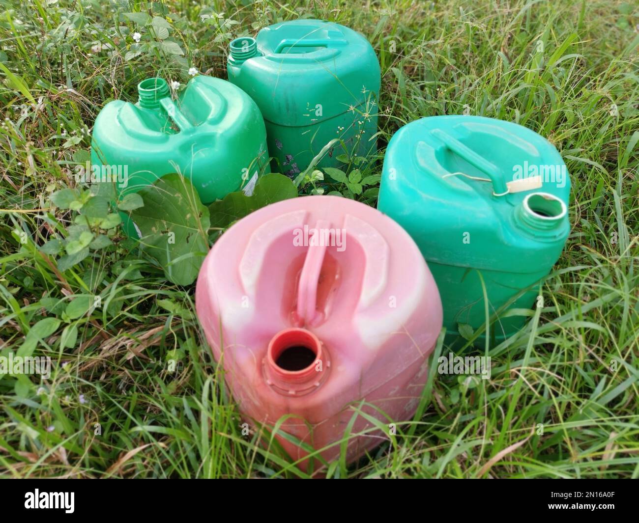 colorful pesticide containers left at the oil palm plantation Stock ...