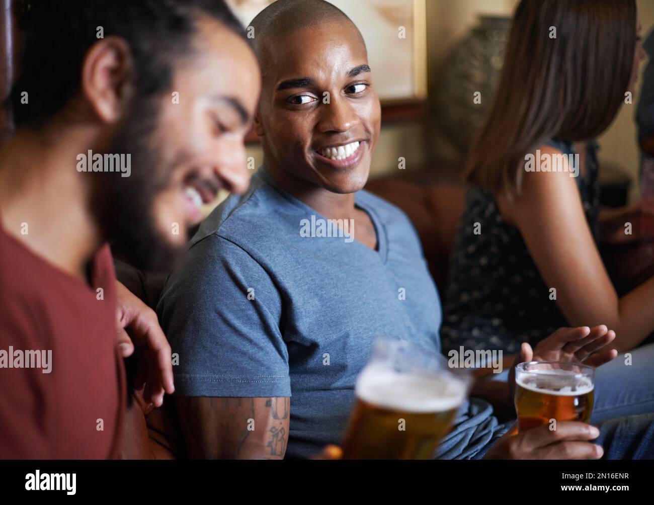 Tastes so good. friends drinking and having fun in a pub Stock Photo ...