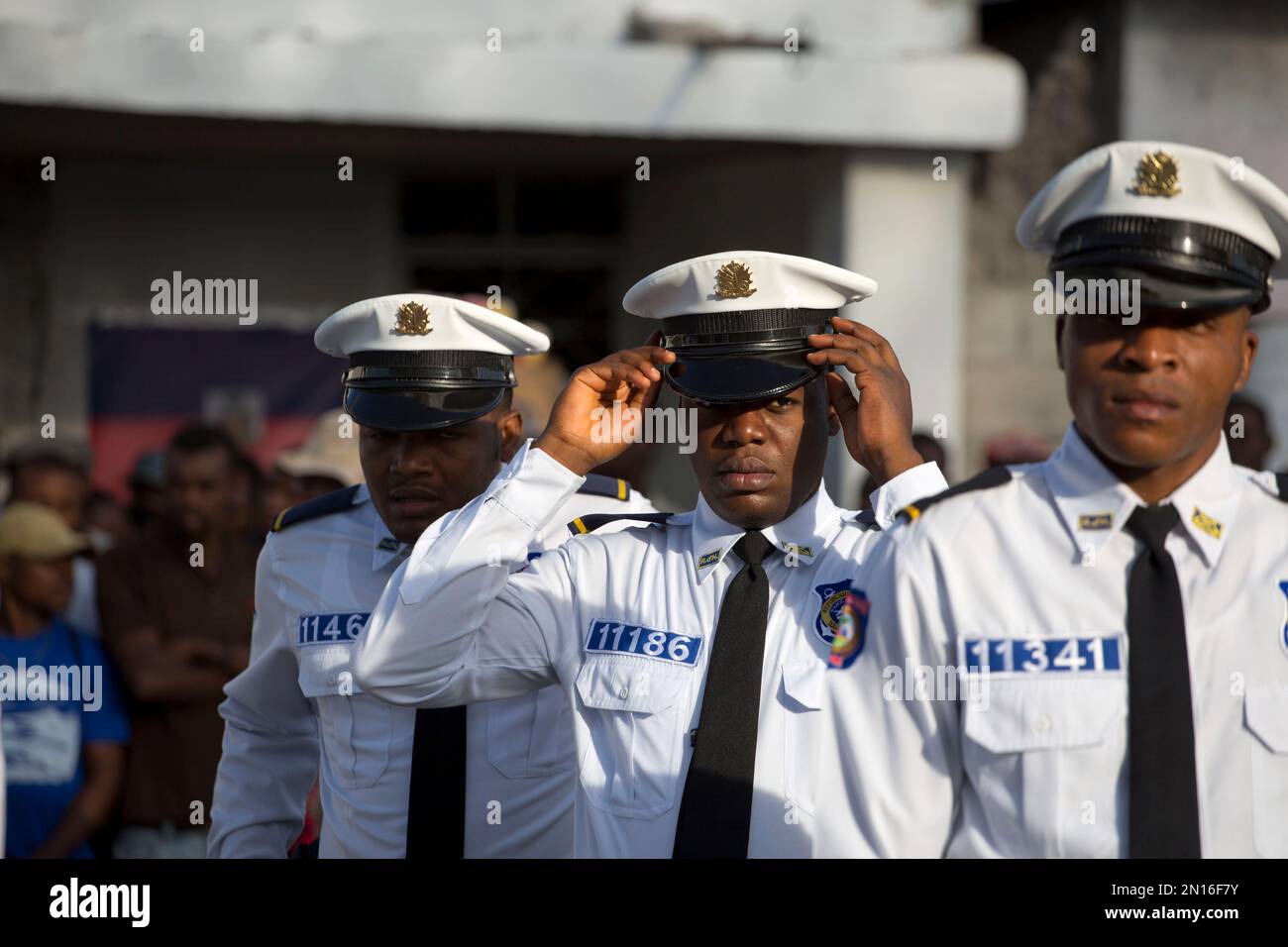 A national police officer arranges his cap before the start of a ...