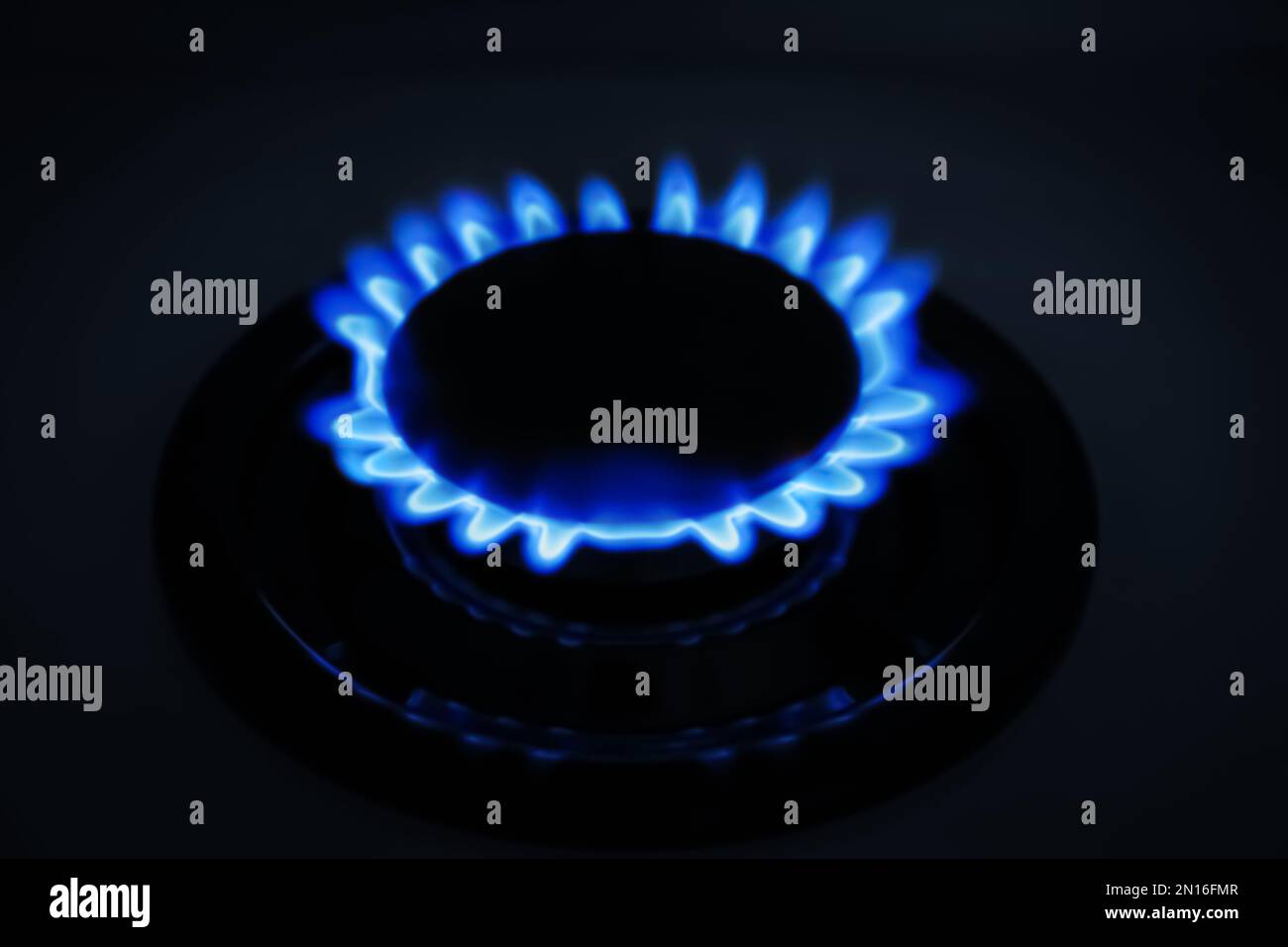 Gas burner of modern stove with burning blue flame at night Stock Photo ...