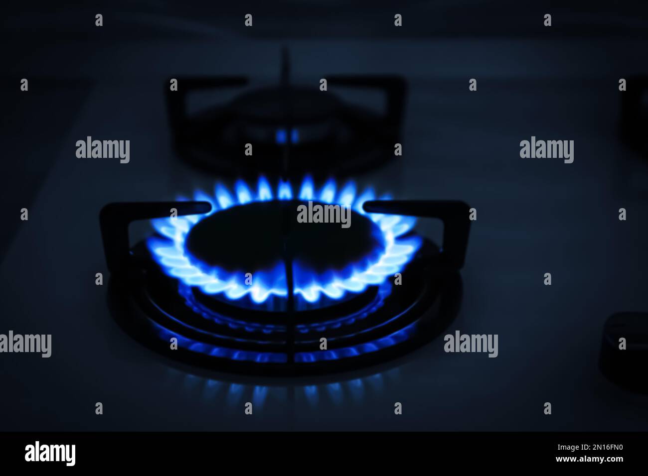 Modern gas cooktop with burning blue flame in kitchen at night Stock ...