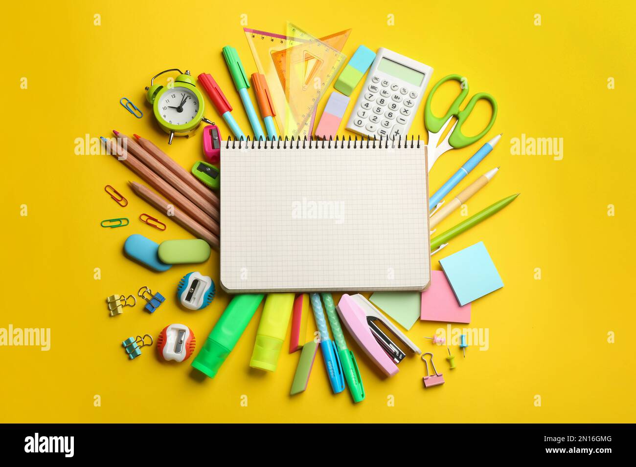 Blank notebook and school stationery on yellow background, flat lay ...