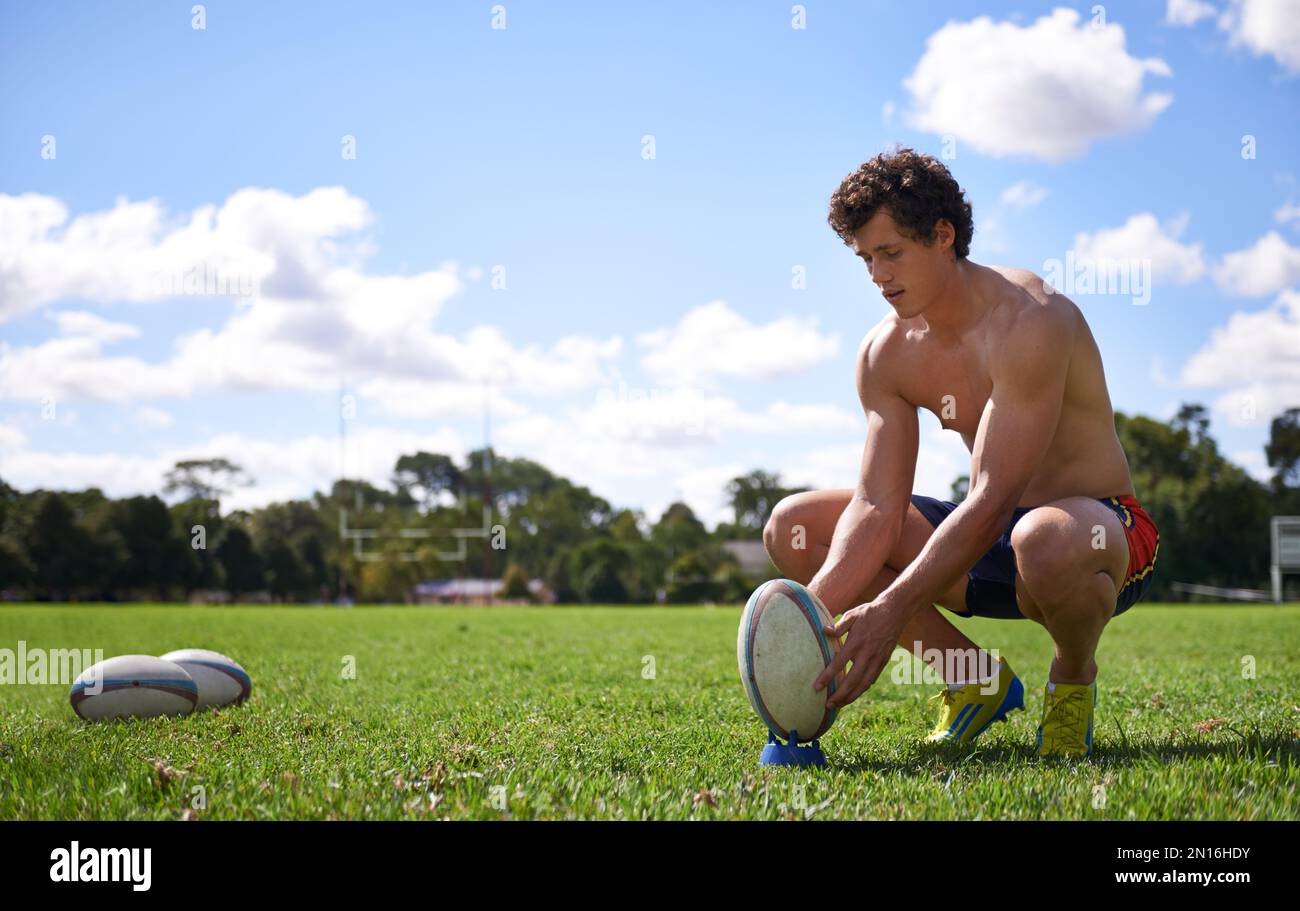 Preparing for a kick. A young rugby player preparing for a kick on a ...