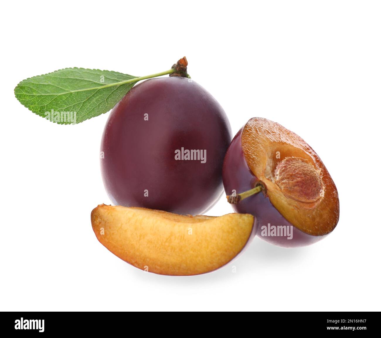 Whole and cut ripe plums with green leaf isolated on white Stock Photo ...