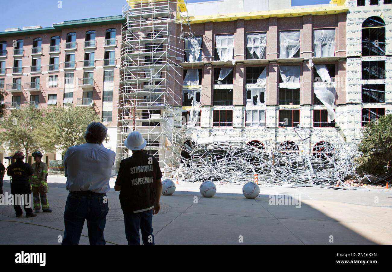 Structural inspectors observe the scene of a scaffolding collapse at a ...