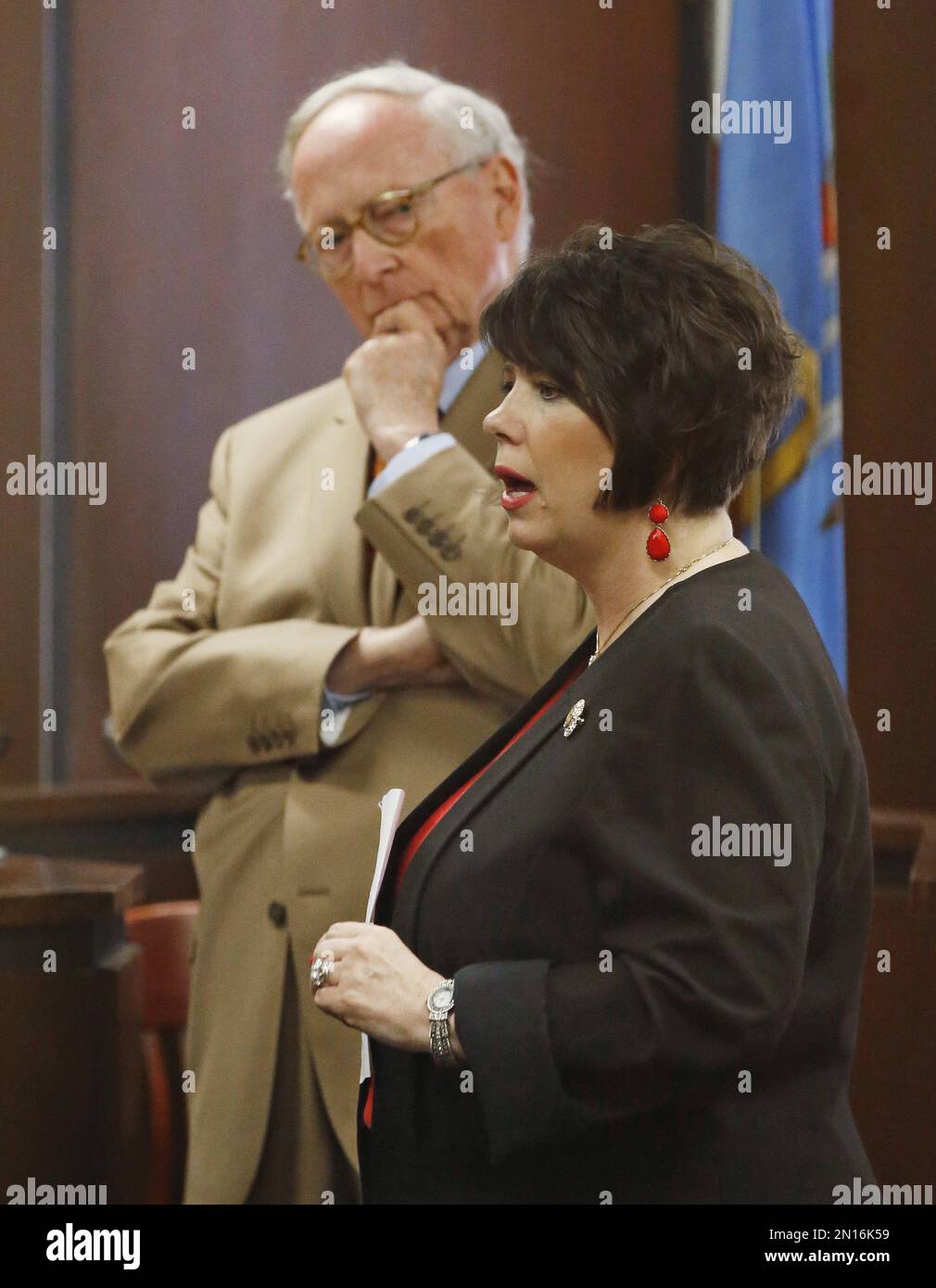 Atrorney Stephen Jones, rear, listens as Cathy Costello, front, widow ...
