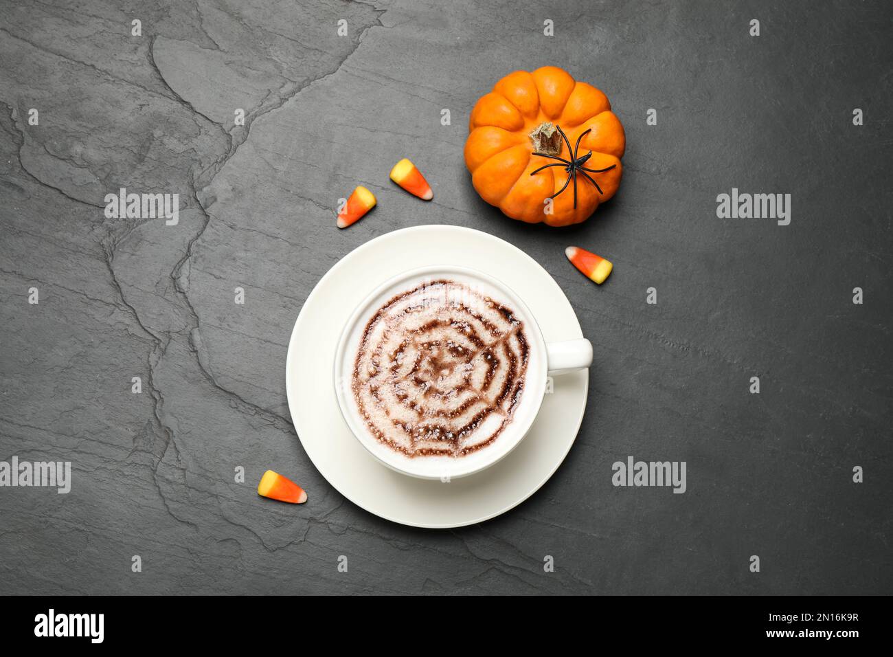 Flat lay composition of coffee with spider's net latte art on grey ...