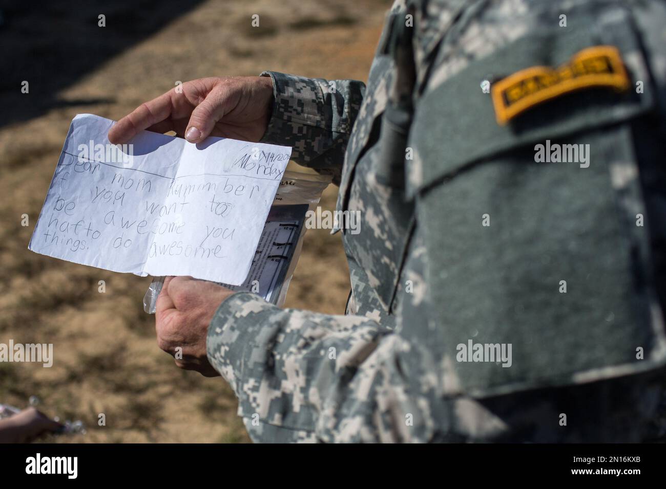 Maj. Lisa Jaster holds a letter her 7-year-old son Zachary wrote her ...