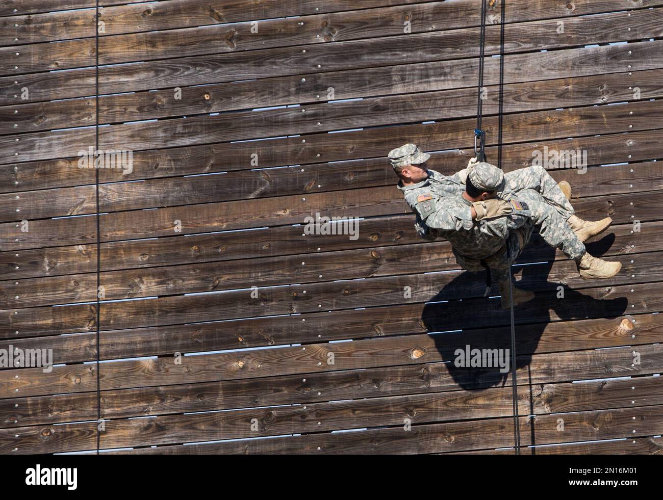 An Army Ranger demonstrates lowering an injured solider down a wall ...