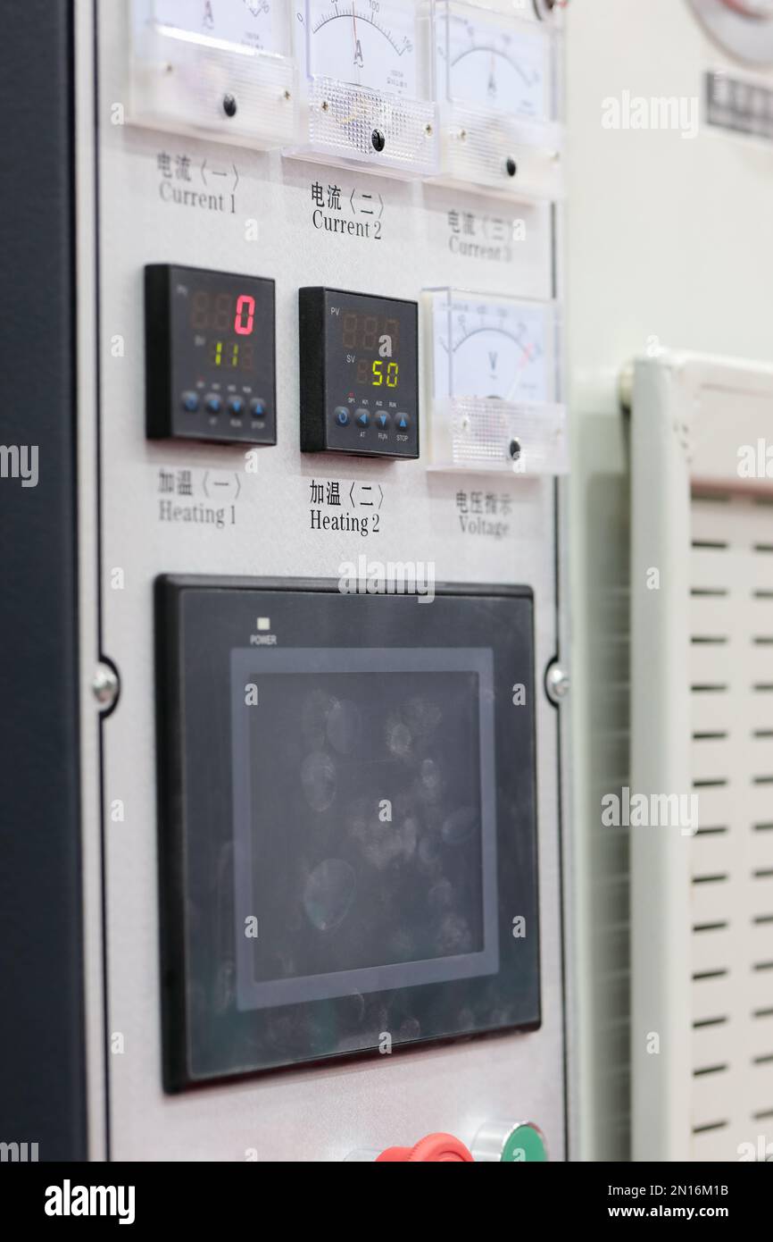 Modern industrial control panel with touch screen, analog gauges ...