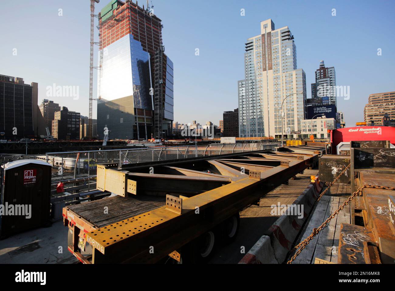 Massive steel structural pieces arrive on flatbed trucks for delivery ...