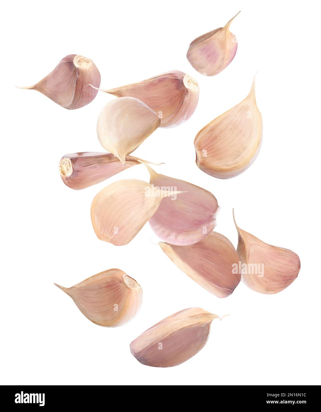 Many garlic cloves falling on white background Stock Photo - Alamy