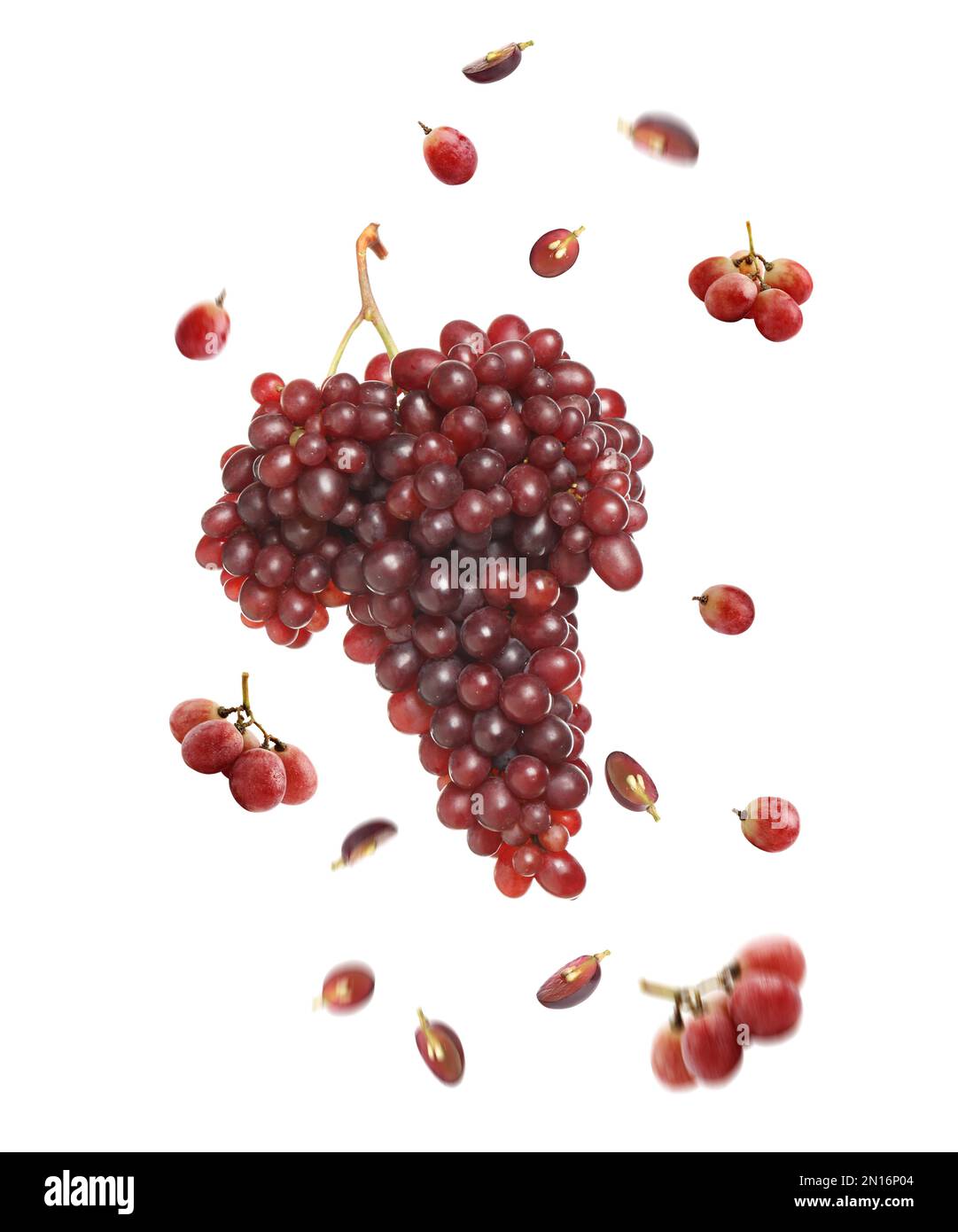 Fresh ripe grapes falling on white background Stock Photo - Alamy