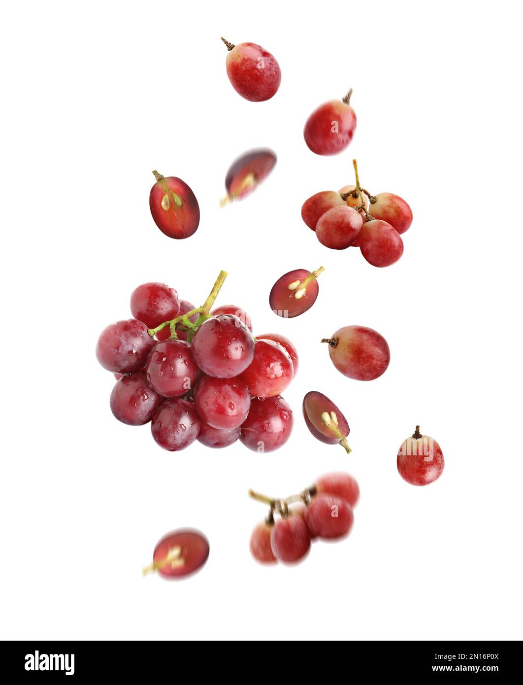Fresh ripe grapes falling on white background Stock Photo - Alamy