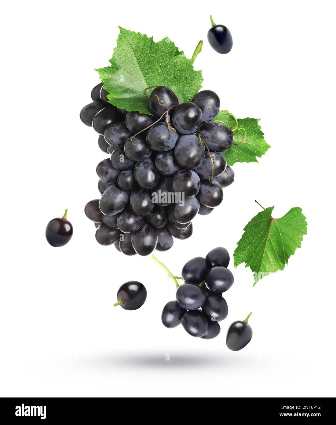 Fresh ripe grapes with green leaves falling on white background Stock ...