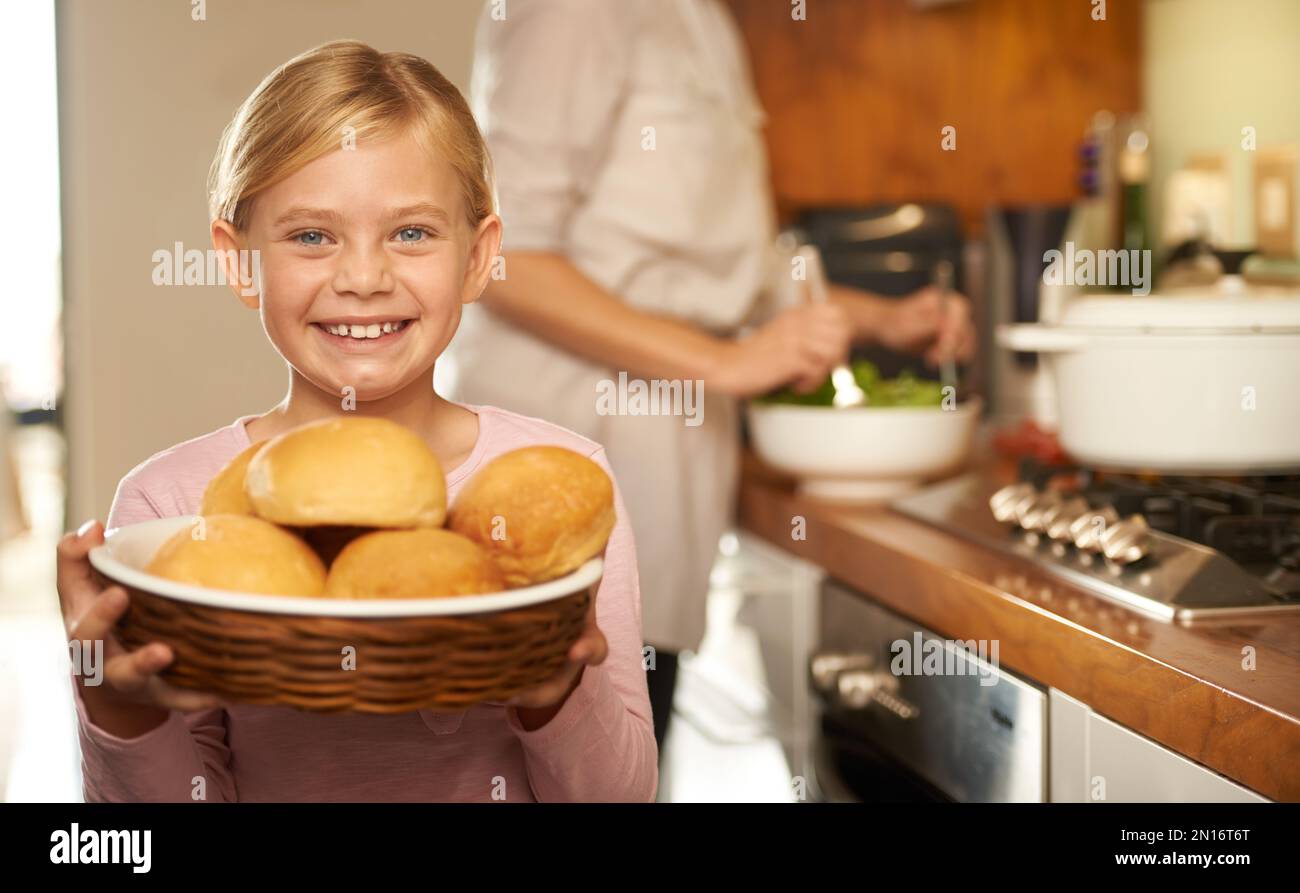 I love helping mommy in the kitchen. Portrait of a cute girl and her ...
