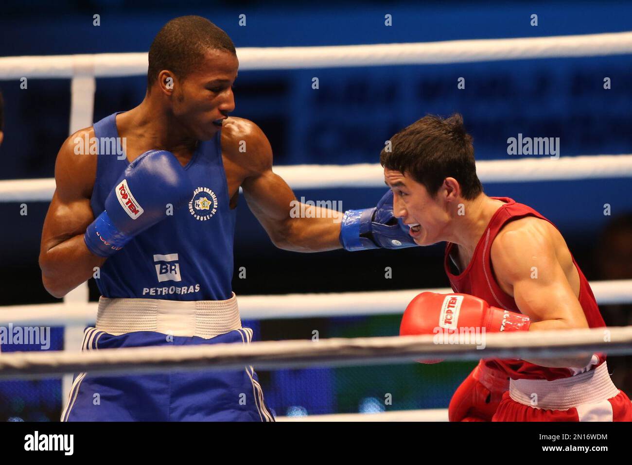Elnur Abduraimov of Uzbekistan, in red, fights with Robson Donato ...