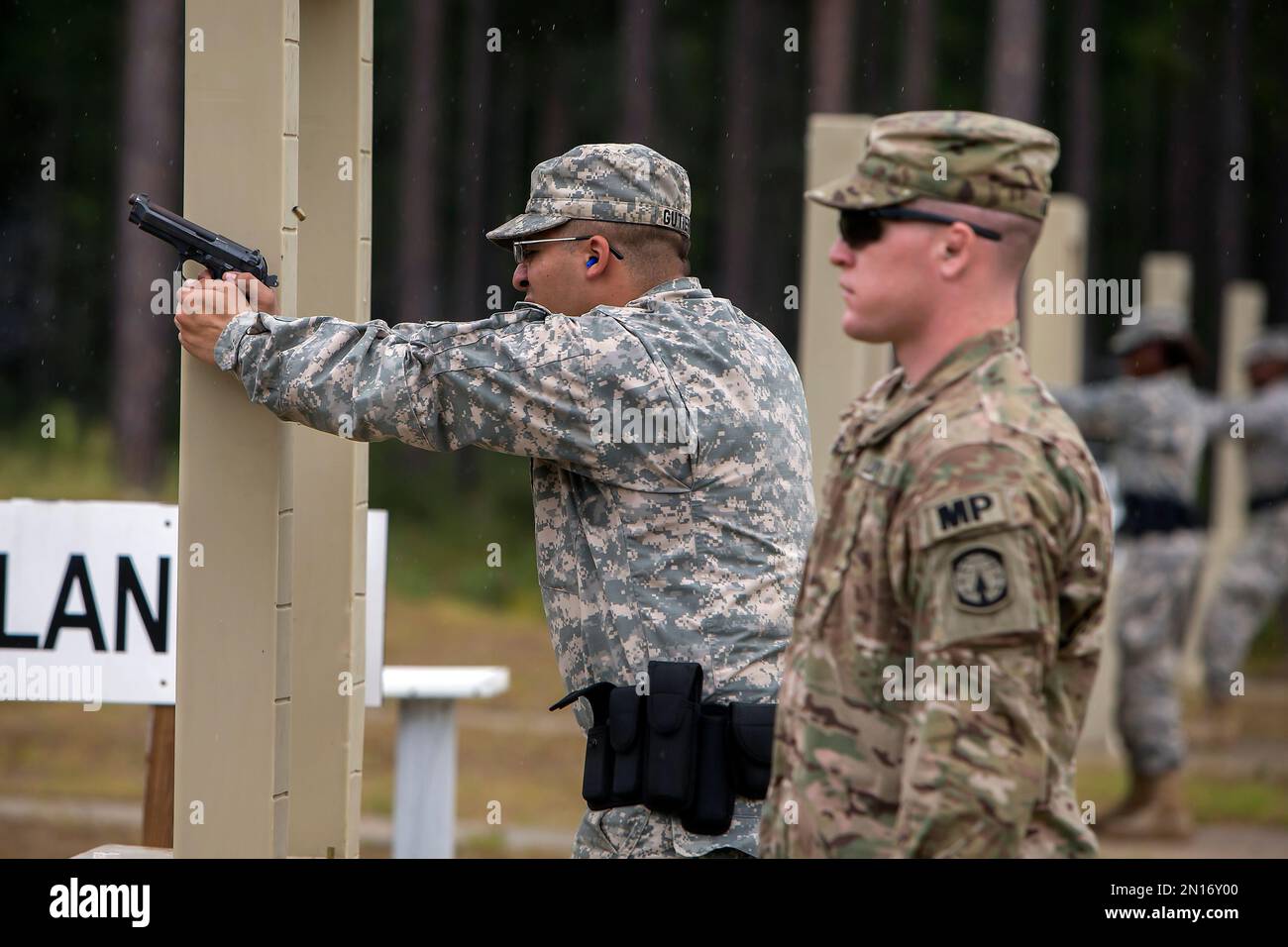 A 9mm case is ejected from the chamber of a Beretta M9 during a ...