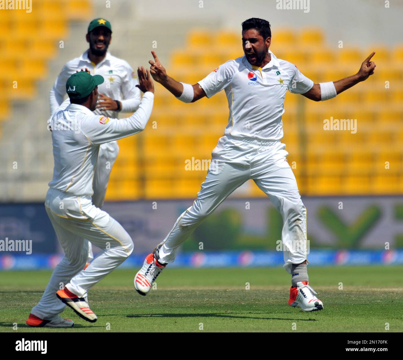 Pakistan's Imran Khan, right, celebrates the wicket of Moeen Ali during ...