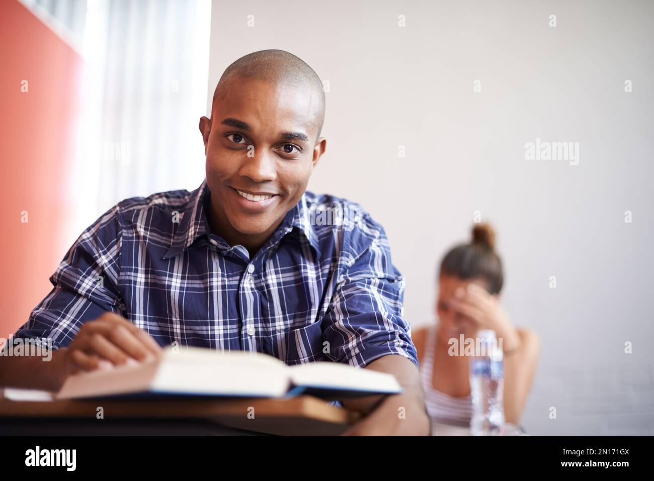 Hes a top student. A cropped shot of a young student in class, studying ...