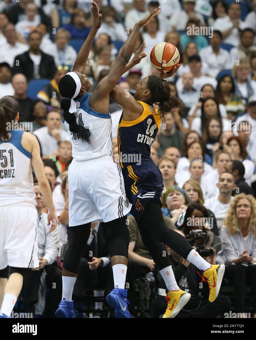 Indiana Fever forward Tamika Catchings, right, shoots on Minnesota Lynx ...