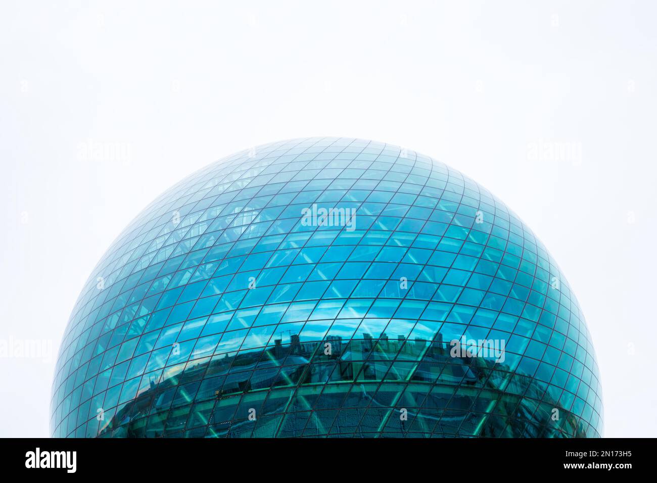 Top of round blue glass building on white sky. Round sphere modern ...