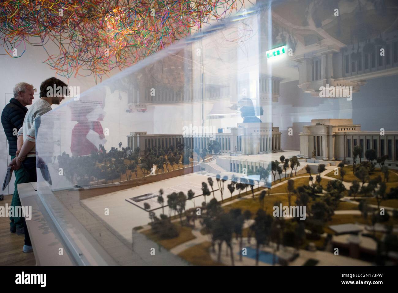 Visitors look on the mock-up architecture building of the Museum of ...
