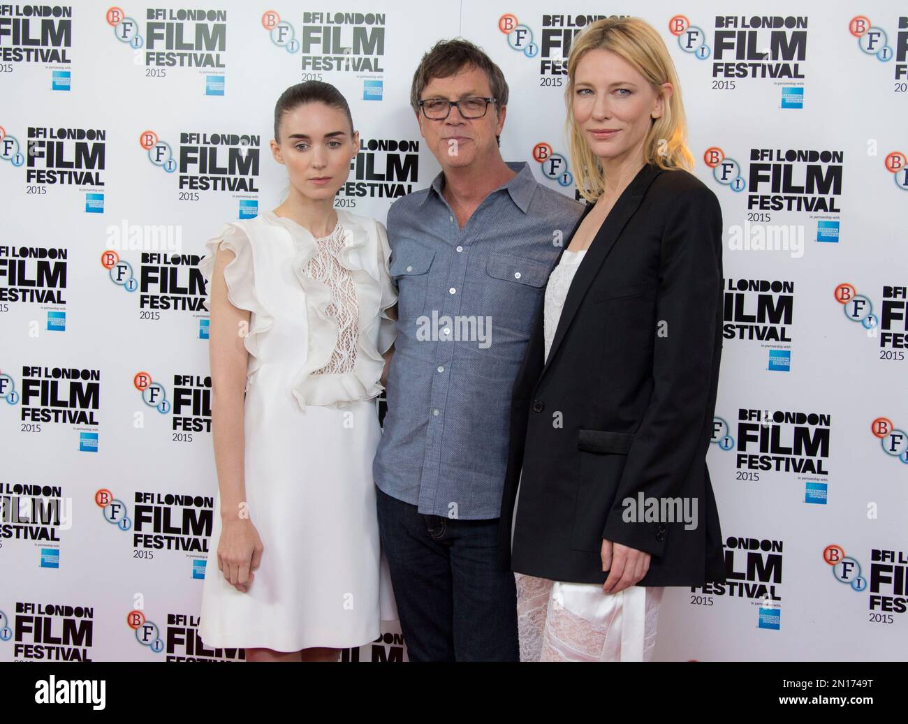 Actors Rooney Mara, left and Cate Blanchett pose for photographers with director Todd Haynes ...