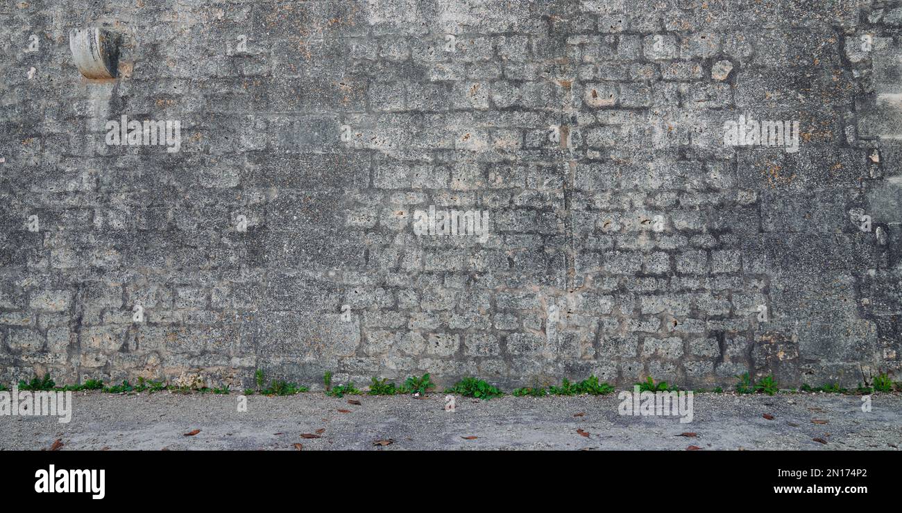 ancient grey tile stone wall in street city background of house facade ...