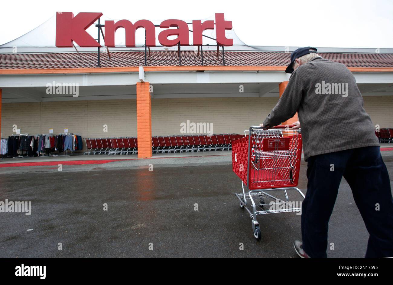 FILE - In this Feb. 23, 2010 file photo, a customer pushes a shopping ...