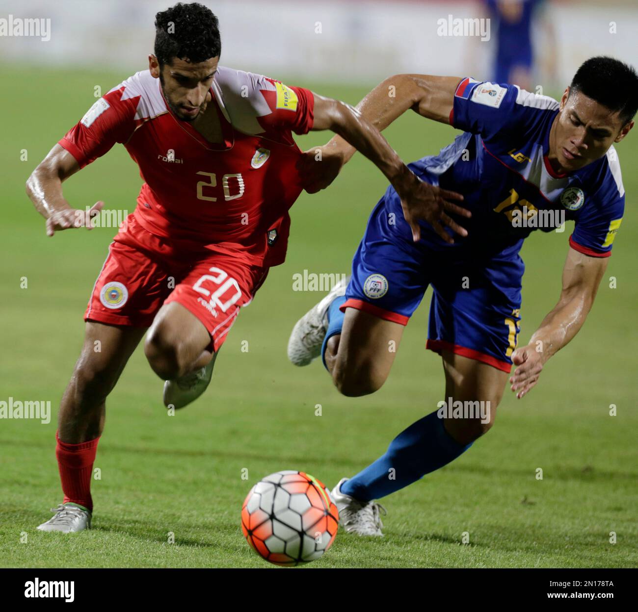 Bahrain's Sami al-Husaini, left, fights for the ball with the ...