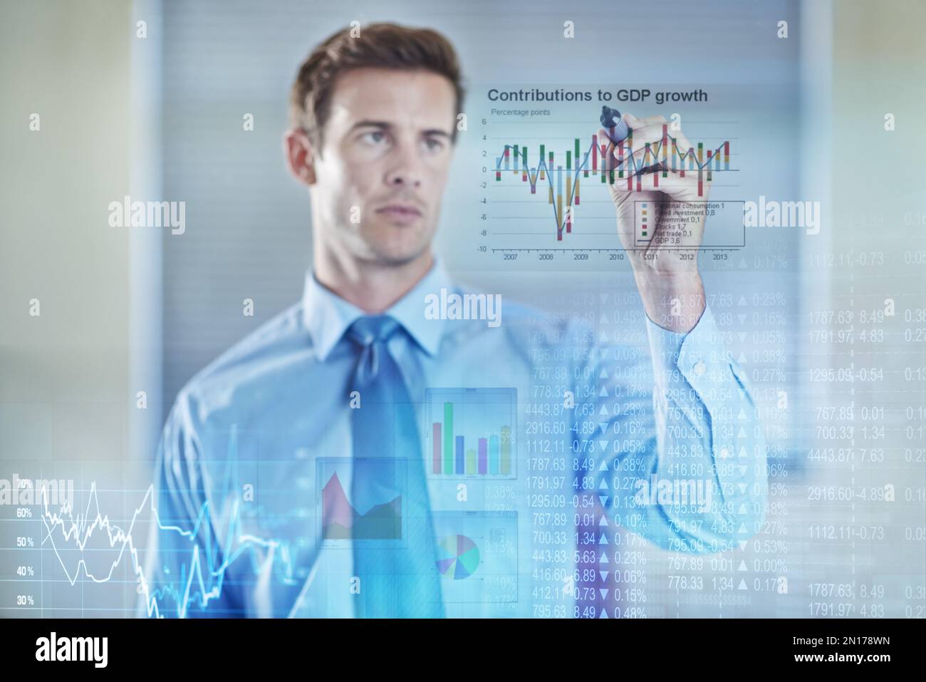 Business at his finegrtips. a handsome young businessman plotting ...