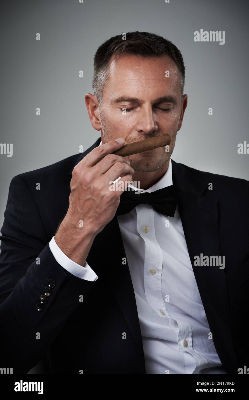 Luxury, wealth and face of man with cigars for smoking habit on gray ...