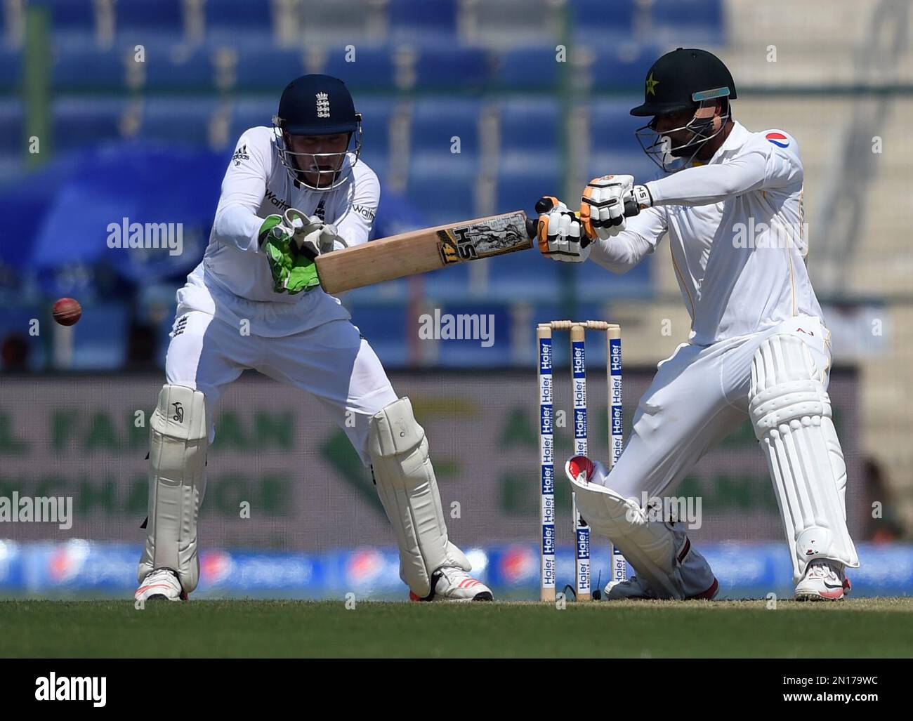 Pakistan batsman Muhammed Hafeez plays a shot, right, as England wicket ...