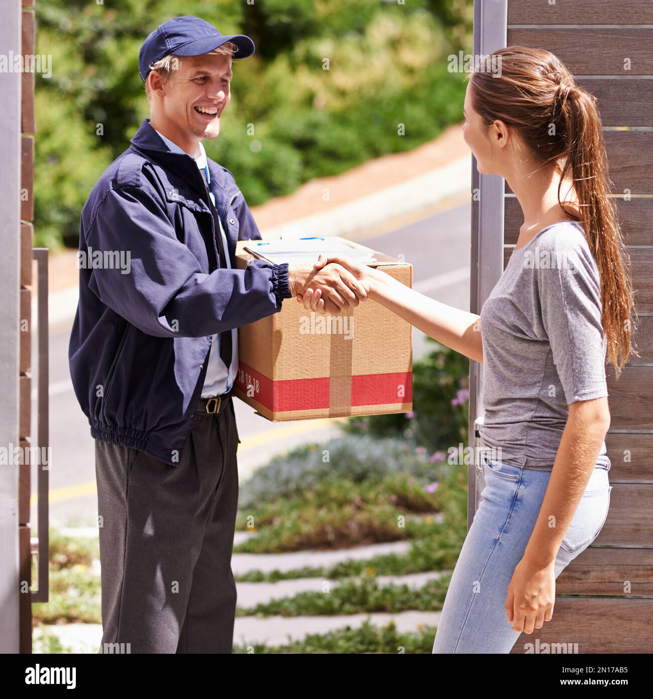 His customer is just as valued as her package. a woman shaking hands ...