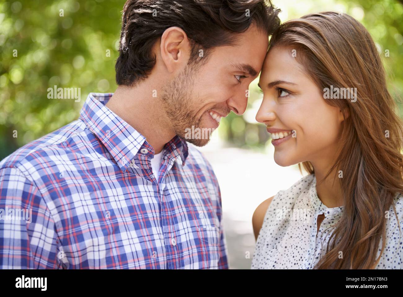 Face, love and couple in park with forehead, touch and bonding against ...