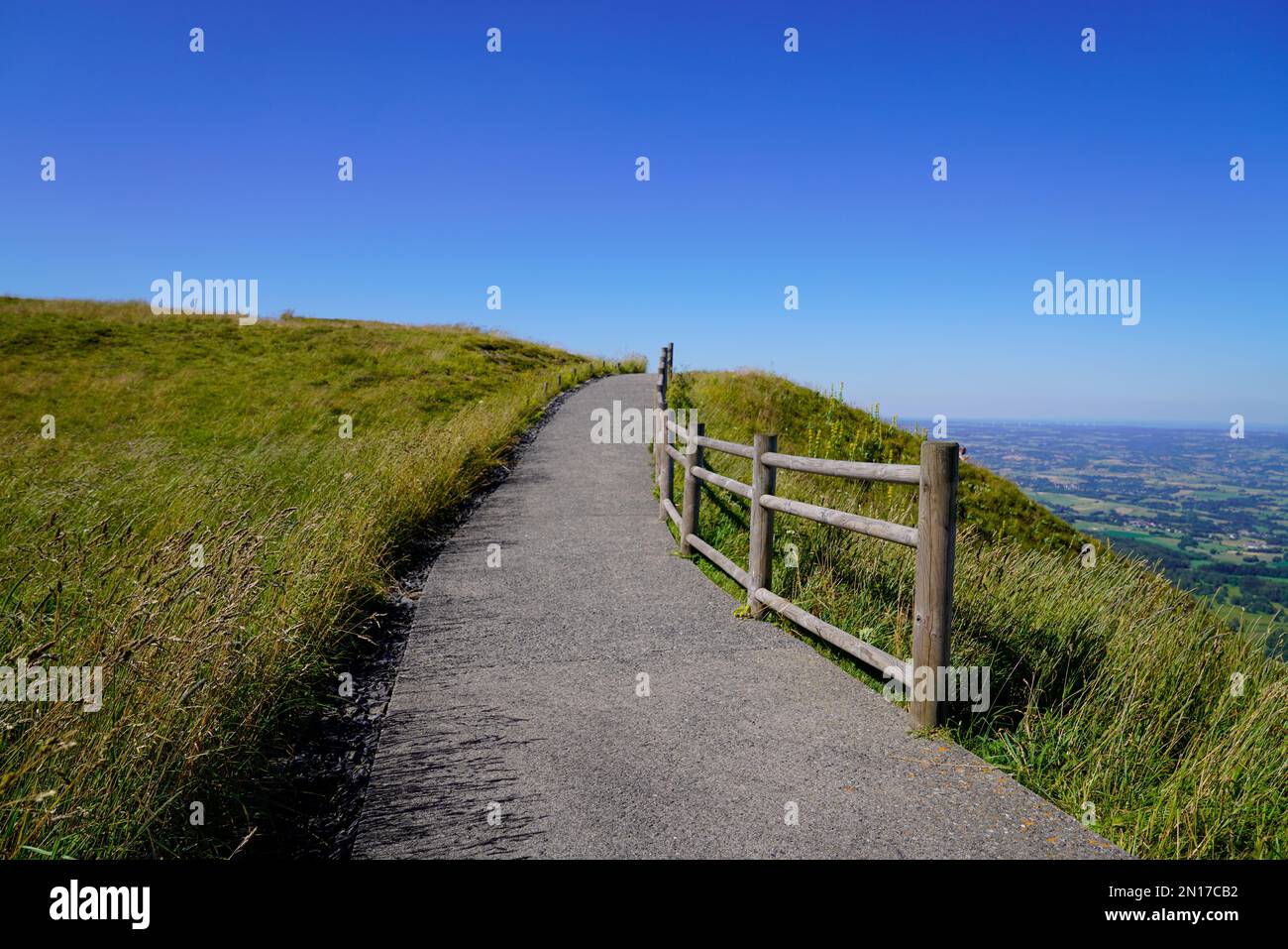 pedestrian path go up in the mountains horizon in french volcano chain ...