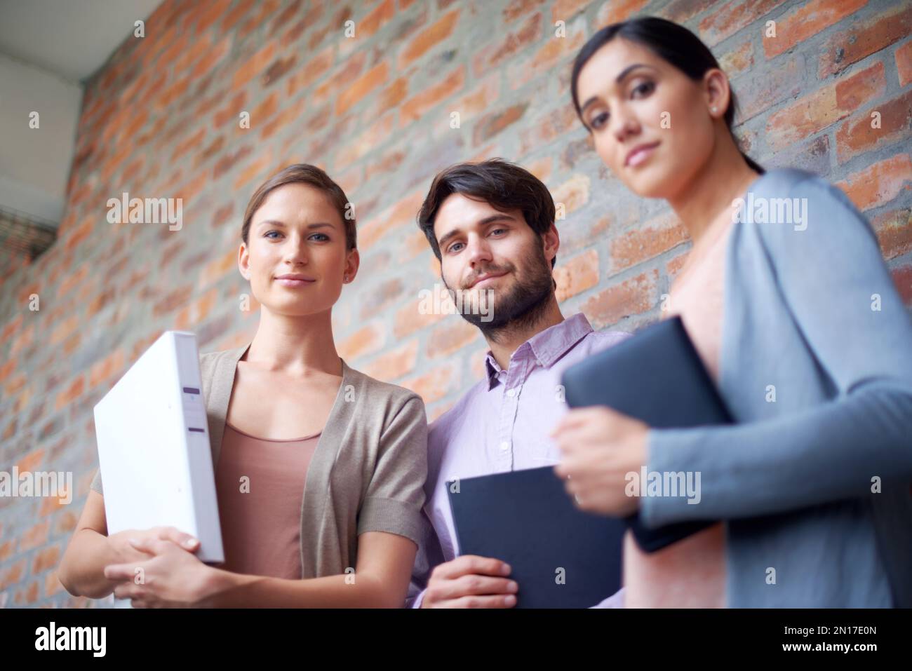 The number one team in the business. three young colleagues in their ...