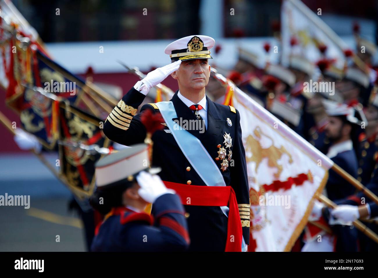 Spain's King Felipe salutes at a military parade during the holiday ...