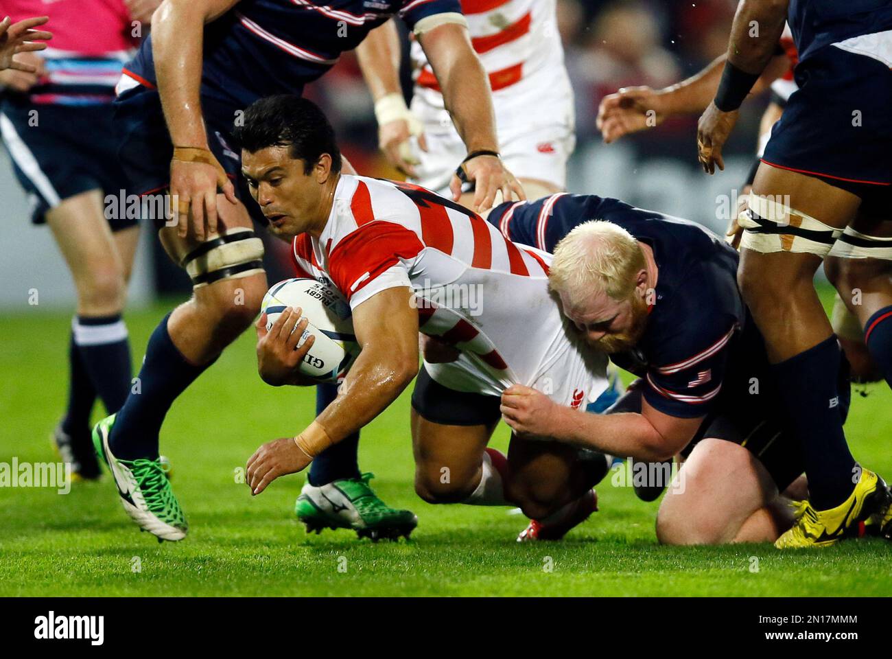 Japan's Craig Wing is brought to the ground by Eric Fry of the USA ...