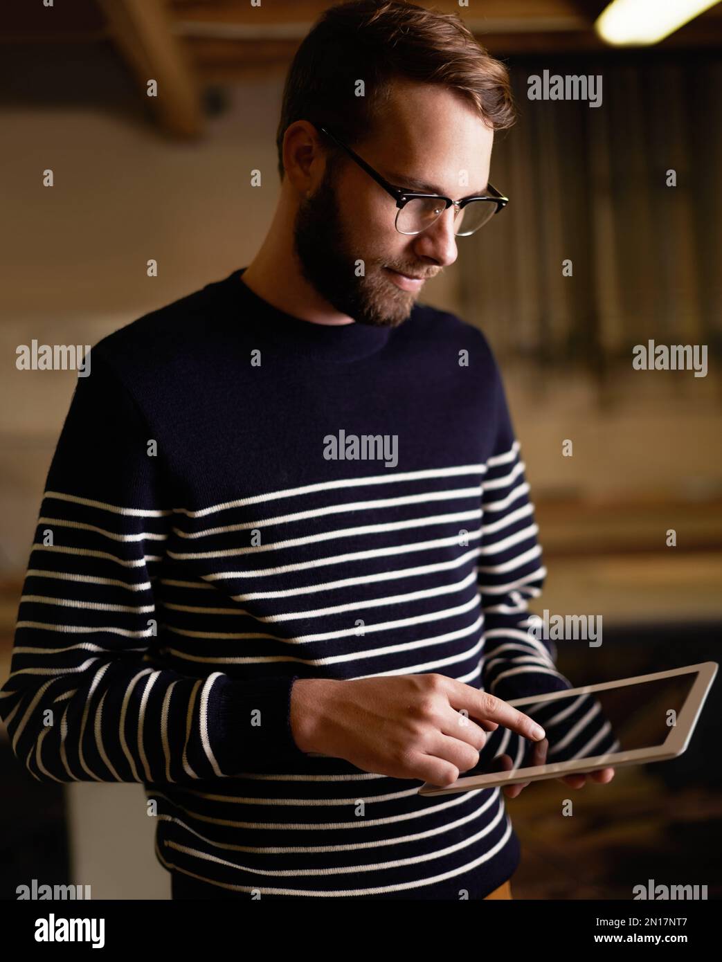 Using touchscreen technology. a hipster using a touchscreen device ...