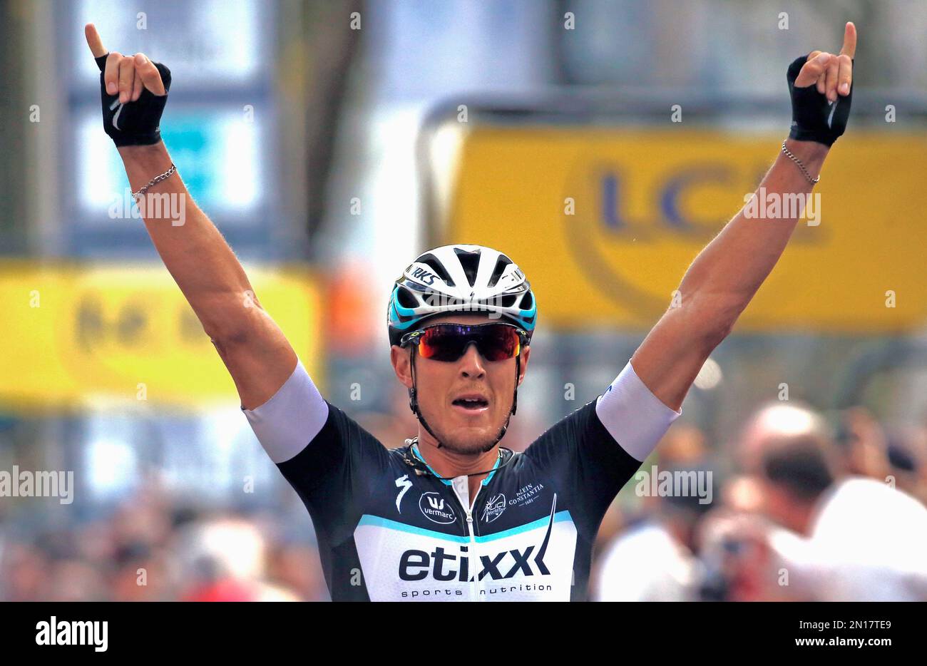 Italy's cyclist Matteo Trentin raises his arms in victory as he crosses ...