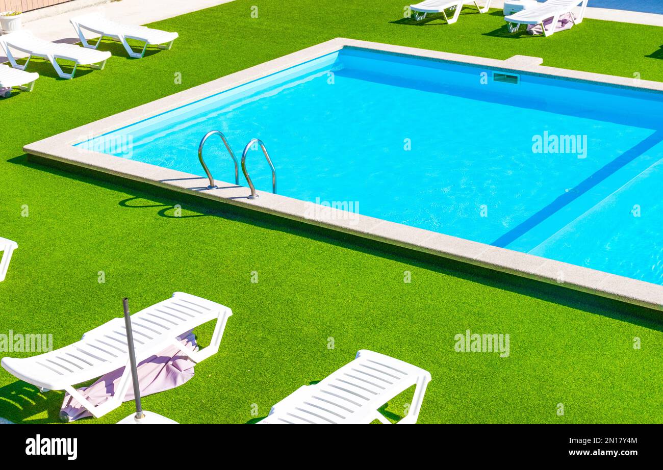 pool design in a modern residence. Sunny weather, sun beds. Vacation ...