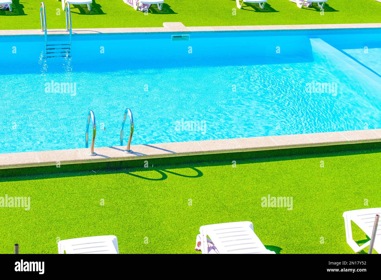 pool design in a modern residence. Sunny weather, sun beds. Vacation ...