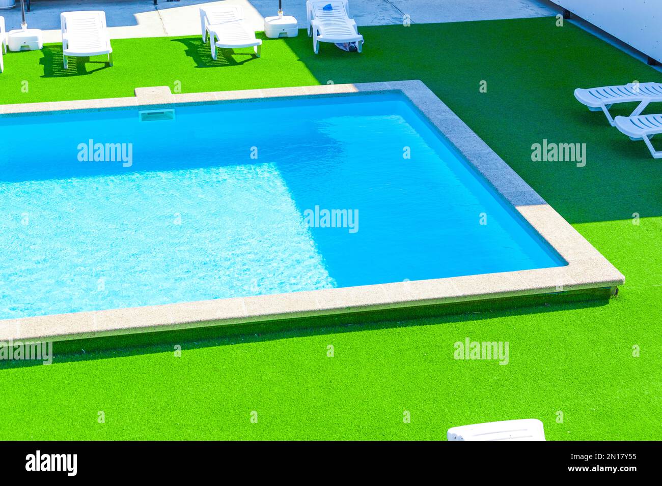 pool design in a modern residence. Sunny weather, sun beds. Vacation ...