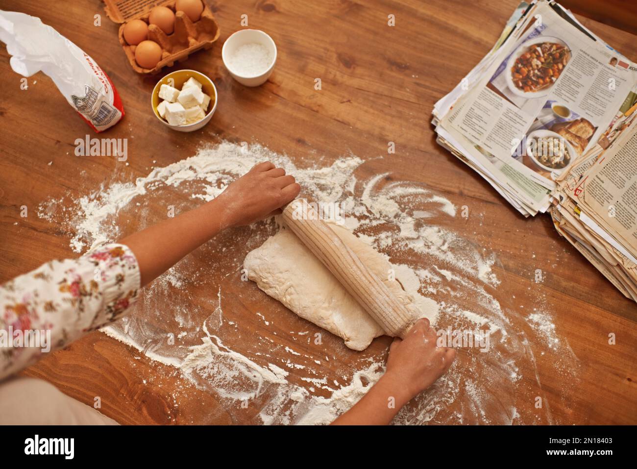Making her famous bread recipe. Cropped view of hands working with fresh dough on a kitchen ...