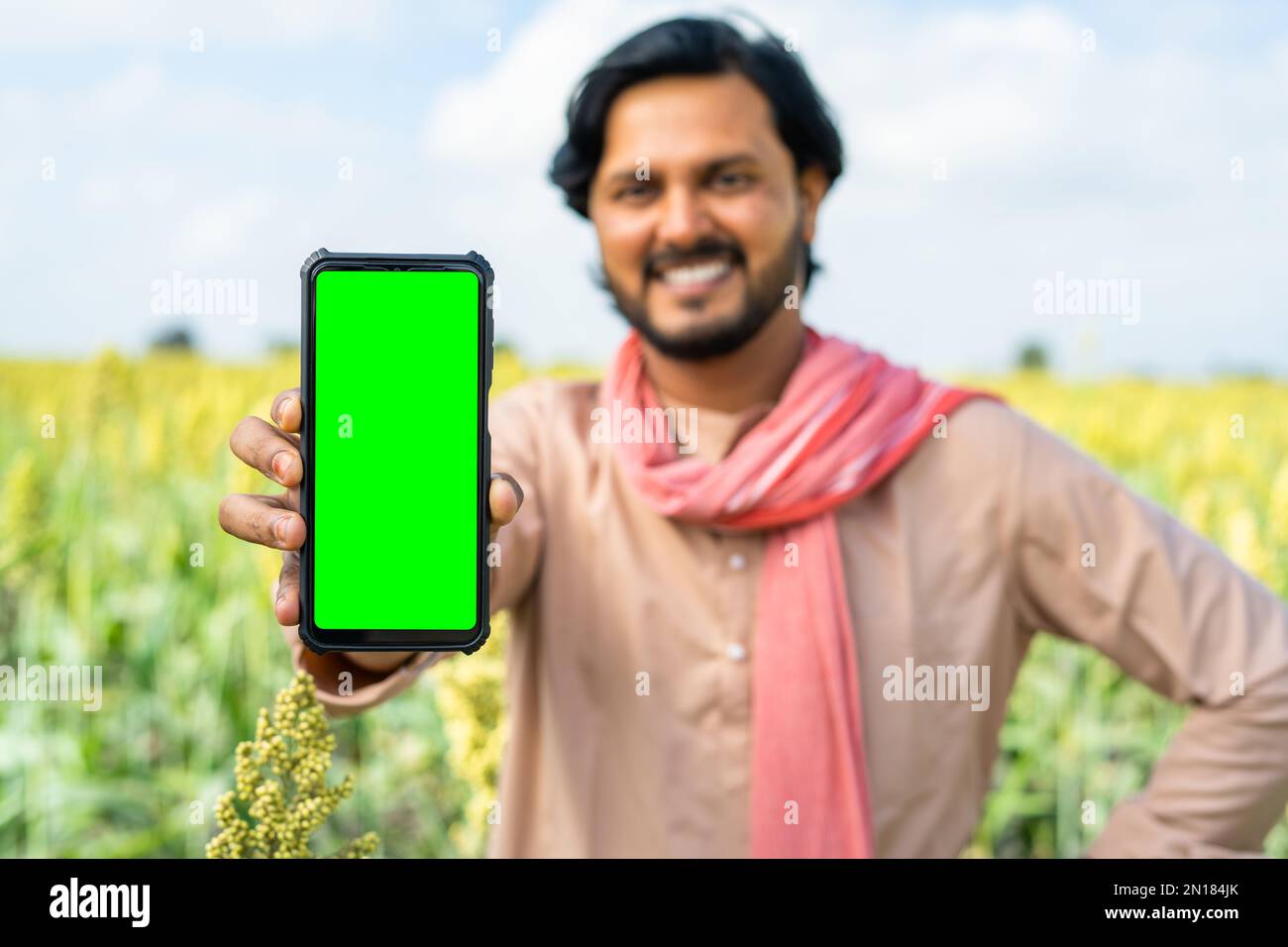 Focus on smartphone, Happy farmer showing green screen mobile phone by ...