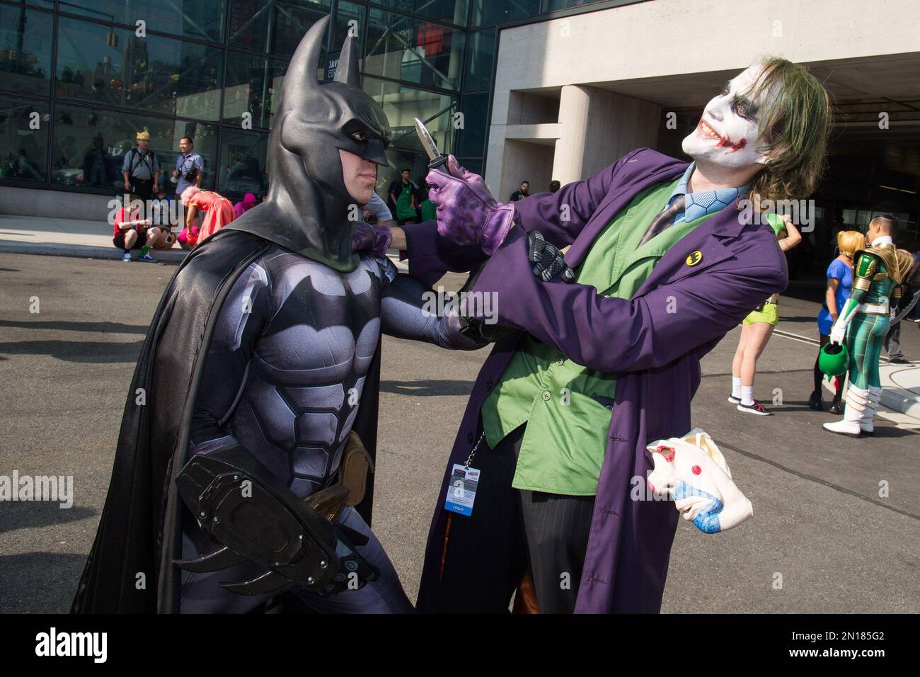 Attendees dressed as Batman and the Joker mock fight outside the Javits ...
