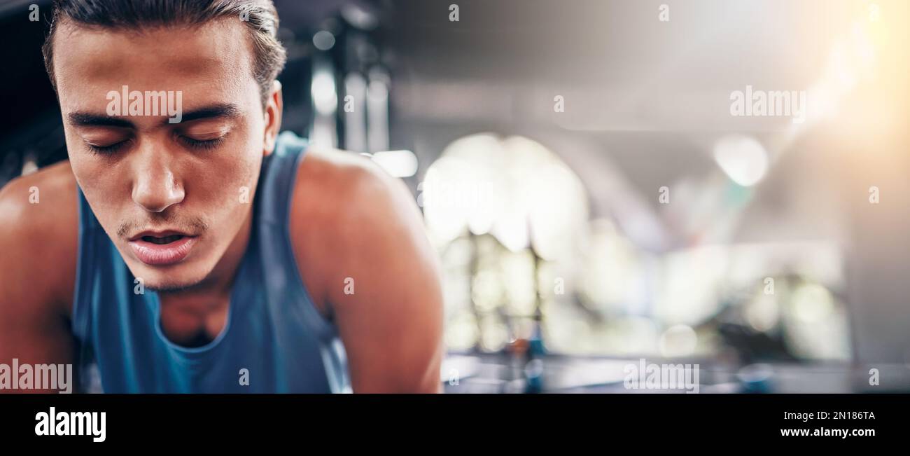 Tired, man and gym for fitness, workout and intense training against bokeh background space ...