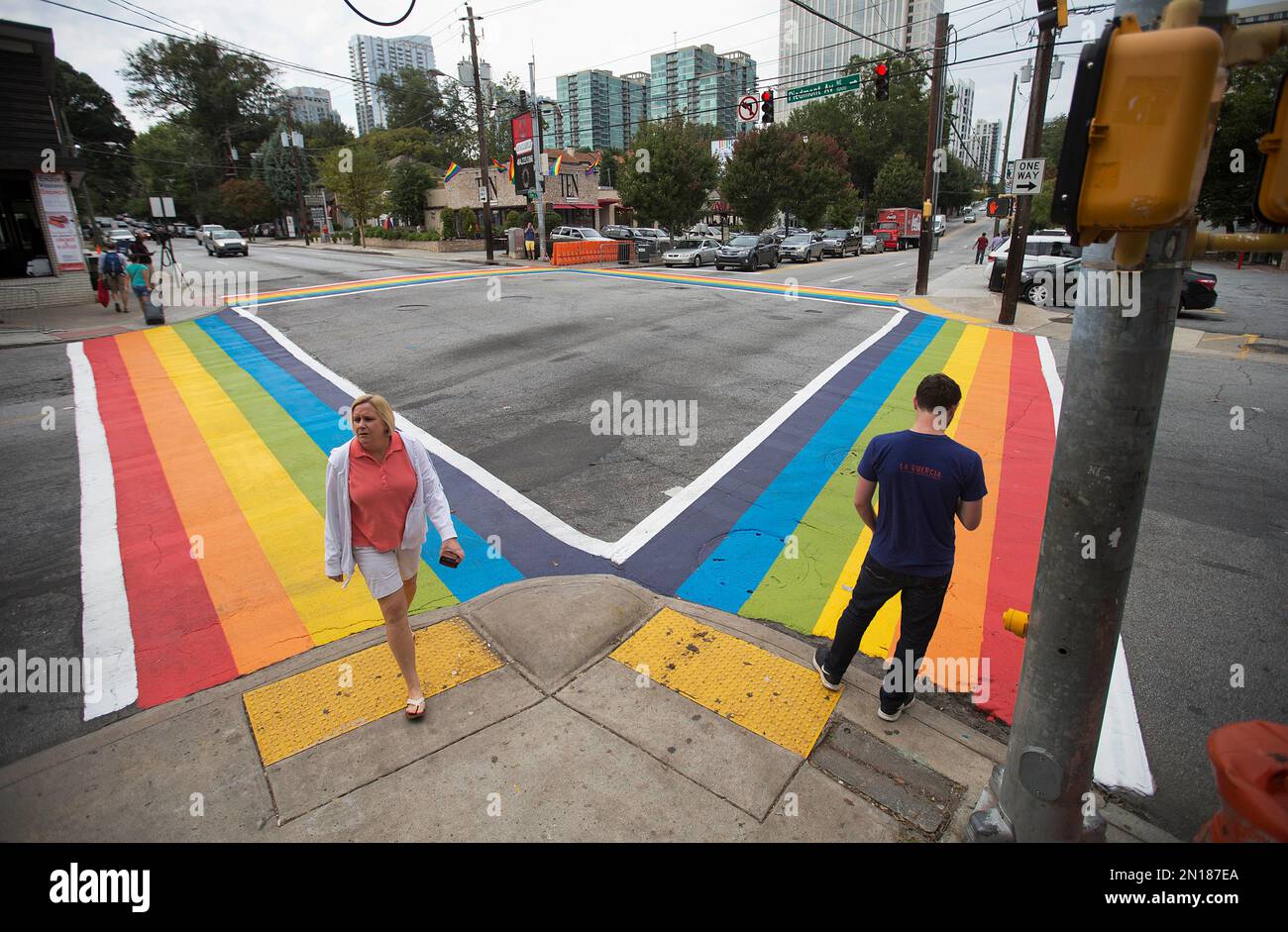 Pedestrians cross a rainbow painted crosswalk in midtown to commemorate ...
